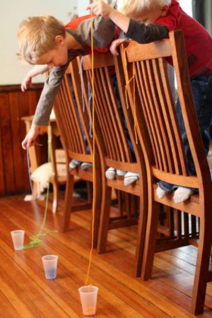 Challenge Kids to Drop the String in the Cup