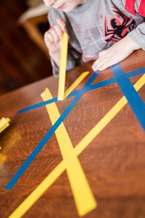 Peeling Tape Activity to Strengthen Little Toddler Fingers - HOAWG