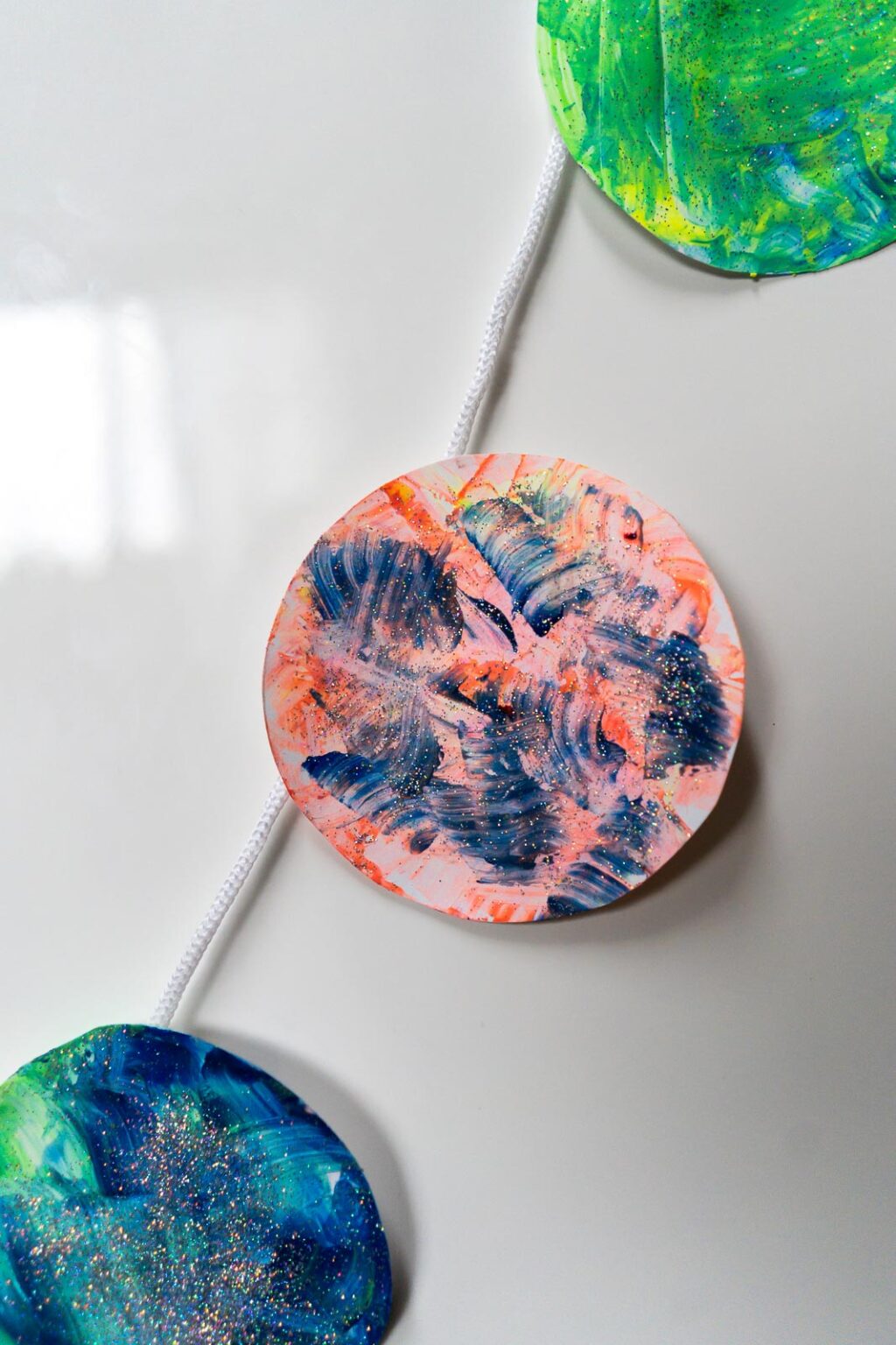 A Great Garland Craft Made From Your Child's Sparkly Scrape Art